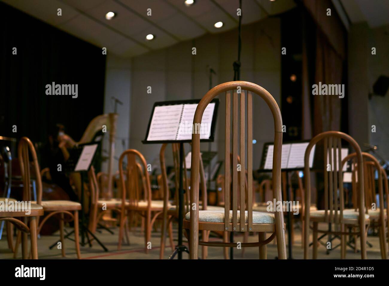 empty concert hall stage with chairs and musical scores before a ...