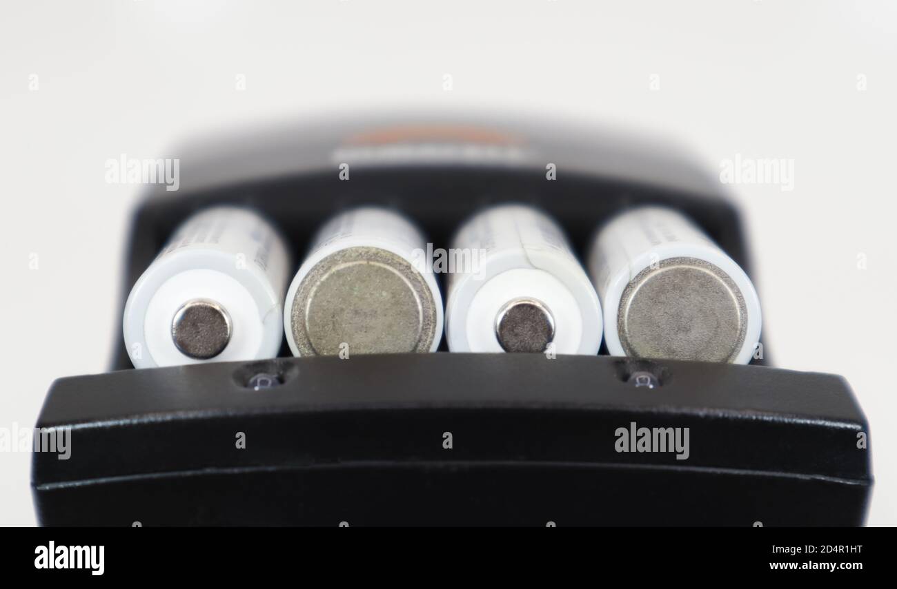 Fast charging of AA batteries. Rechargeable batteries in a black ...