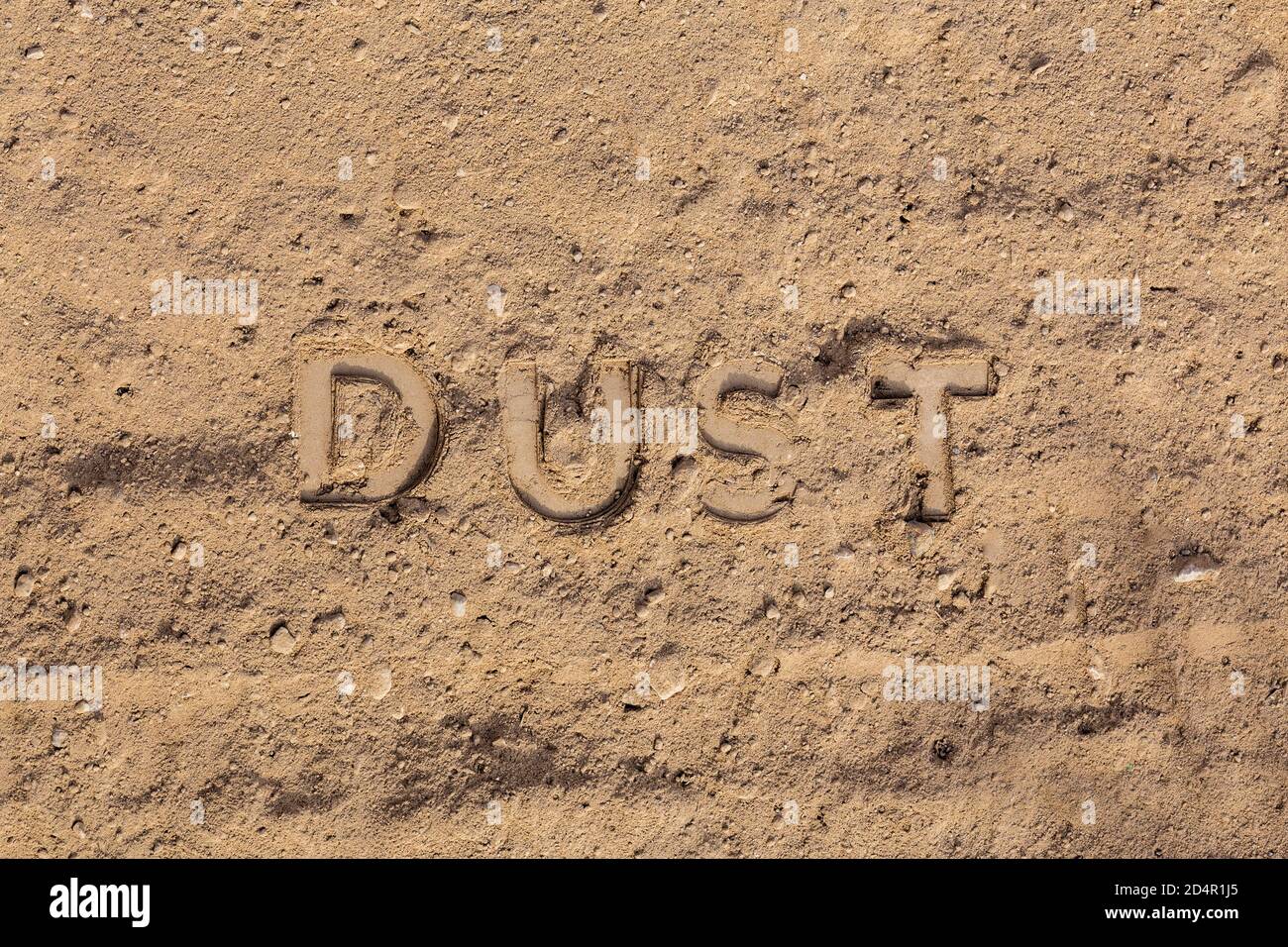the word dust embossed on dusty road surface in flat lay perspective ...