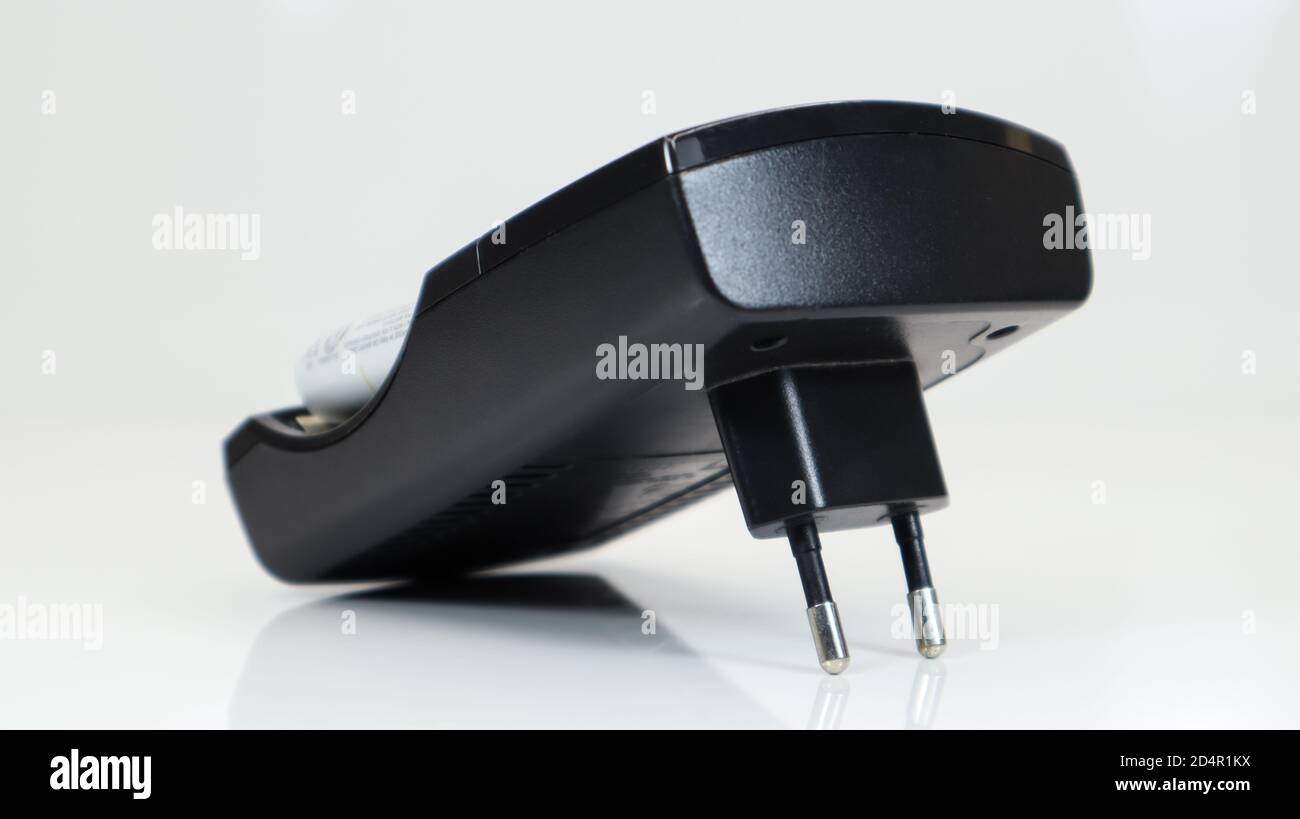 Fast charging of AA batteries. Rechargeable batteries in a black ...