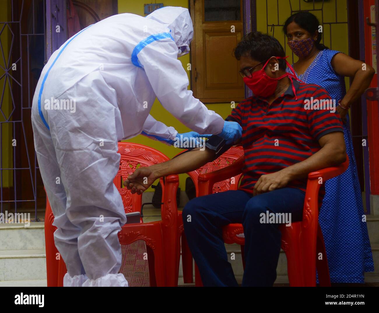 A team of health workers and doctors are doing house to house checkups ...