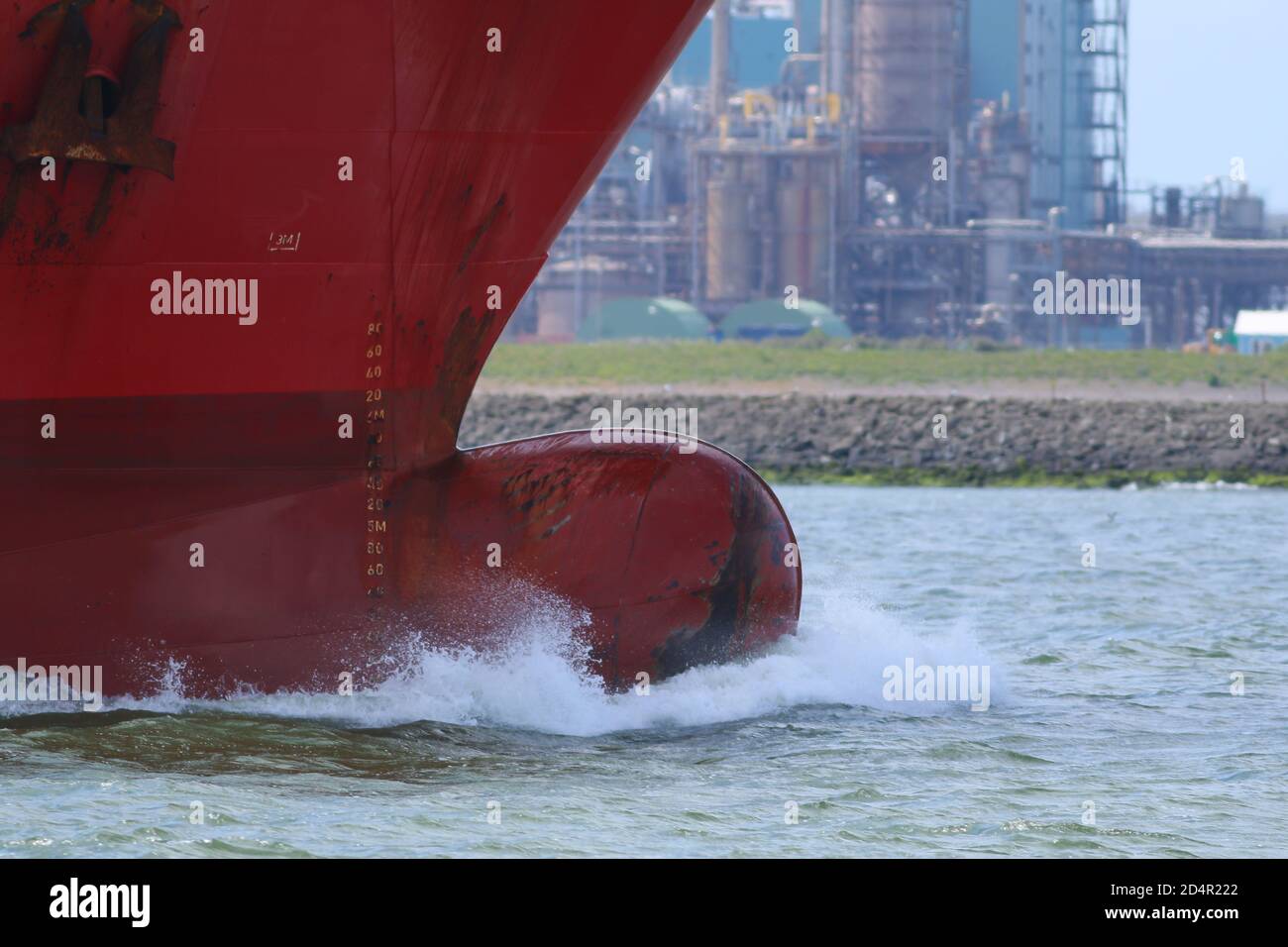Bulbous bow of a ship with wave breaking before it as it passes ...