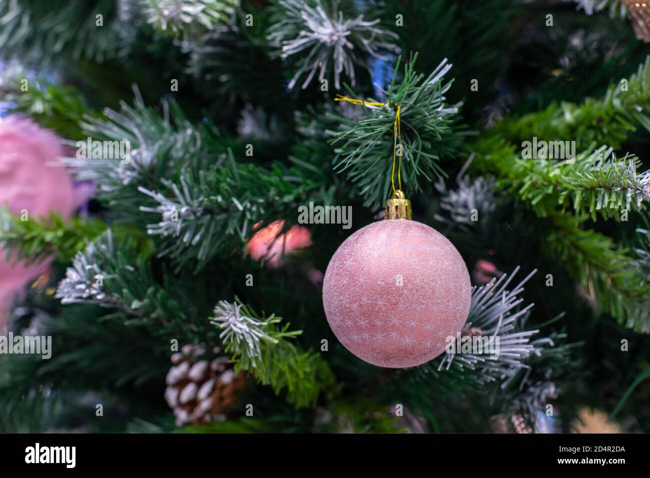 Christmas tree with matte pink ball with snowflakes. Festive Christmas ...