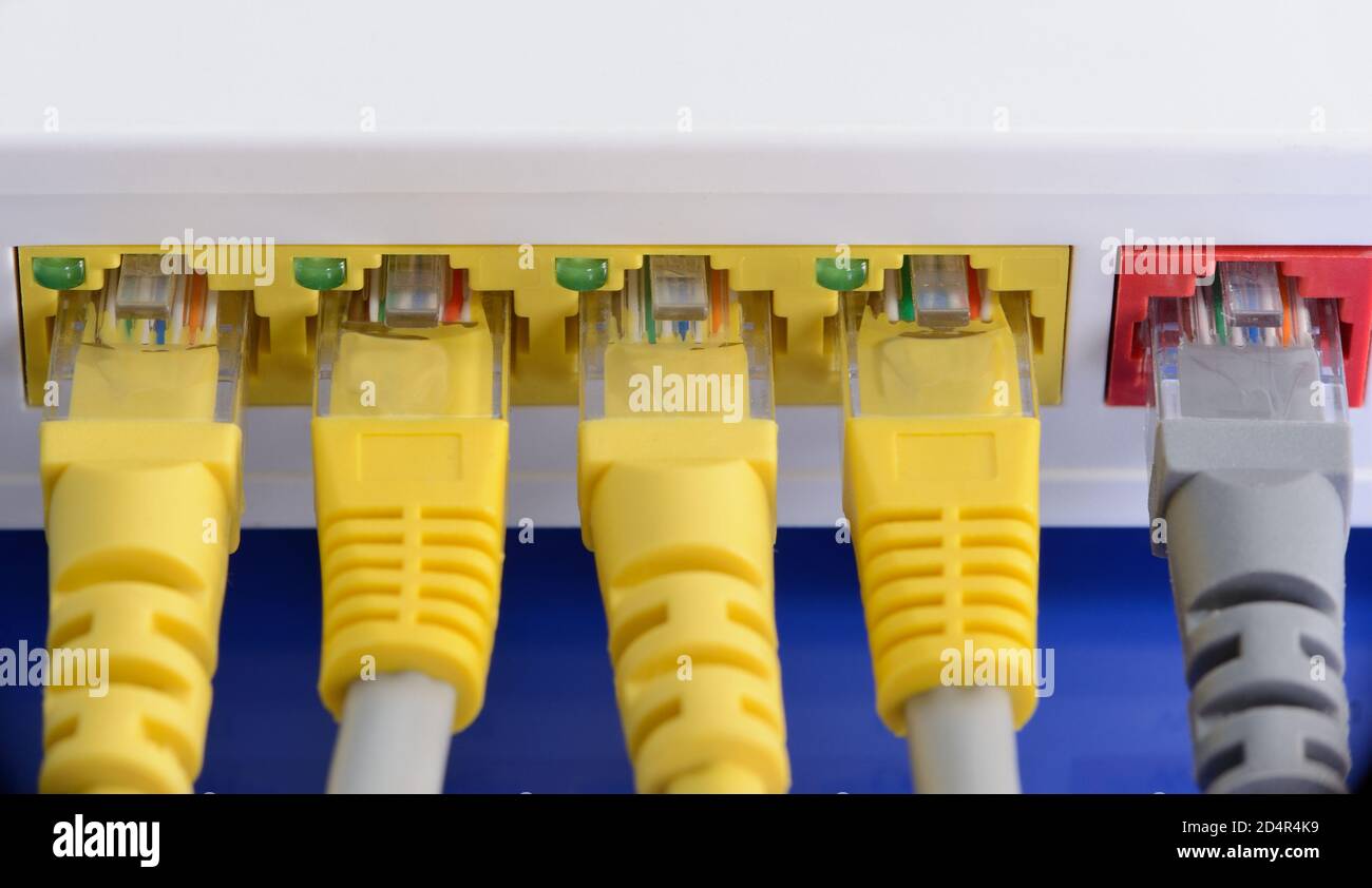 Several RJ45 LAN cables connected to router formed communication ...