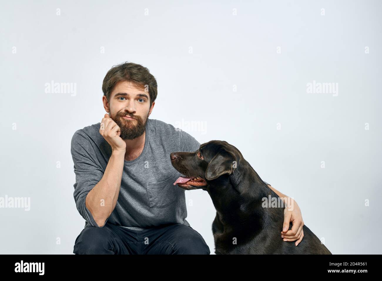 happy owner with pet black dog training model emotions Stock Photo - Alamy
