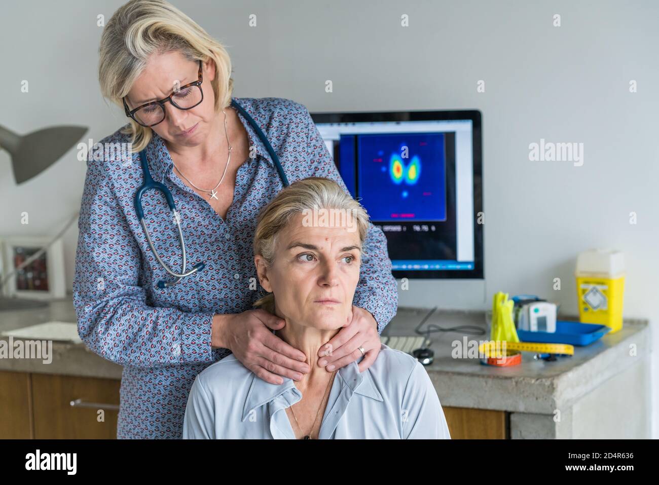 Doctor examining the thyroid gland of a patient Stock Photo - Alamy