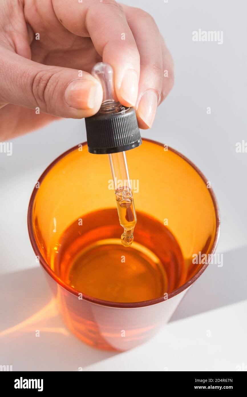 Woman taking drops of medicine Stock Photo - Alamy