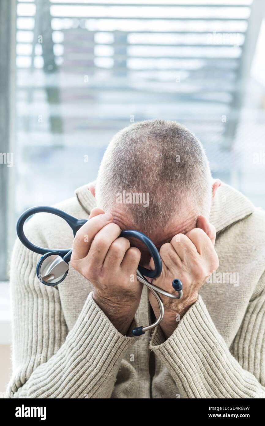 Doctor looking depressed Stock Photo - Alamy