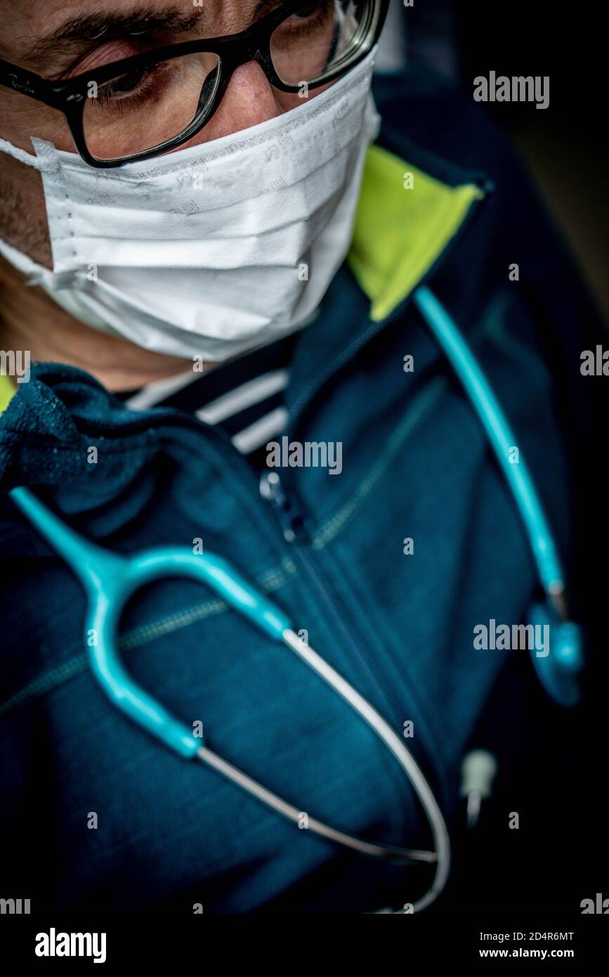 Doctor wearing respiratory protection mask during medical consultation ...