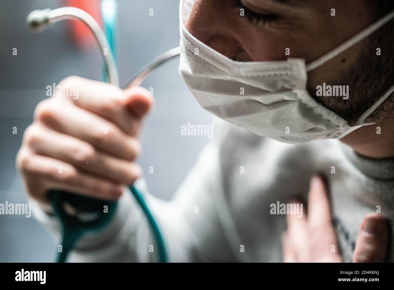 Doctor wearing respiratory protection mask during medical consultation ...