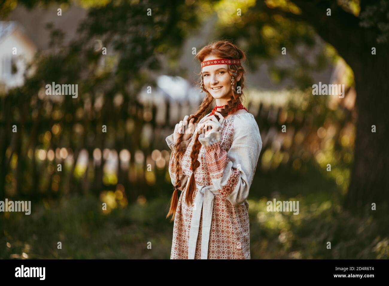 A beautiful Slavic girl with long blonde hair and brown eyes in a white ...