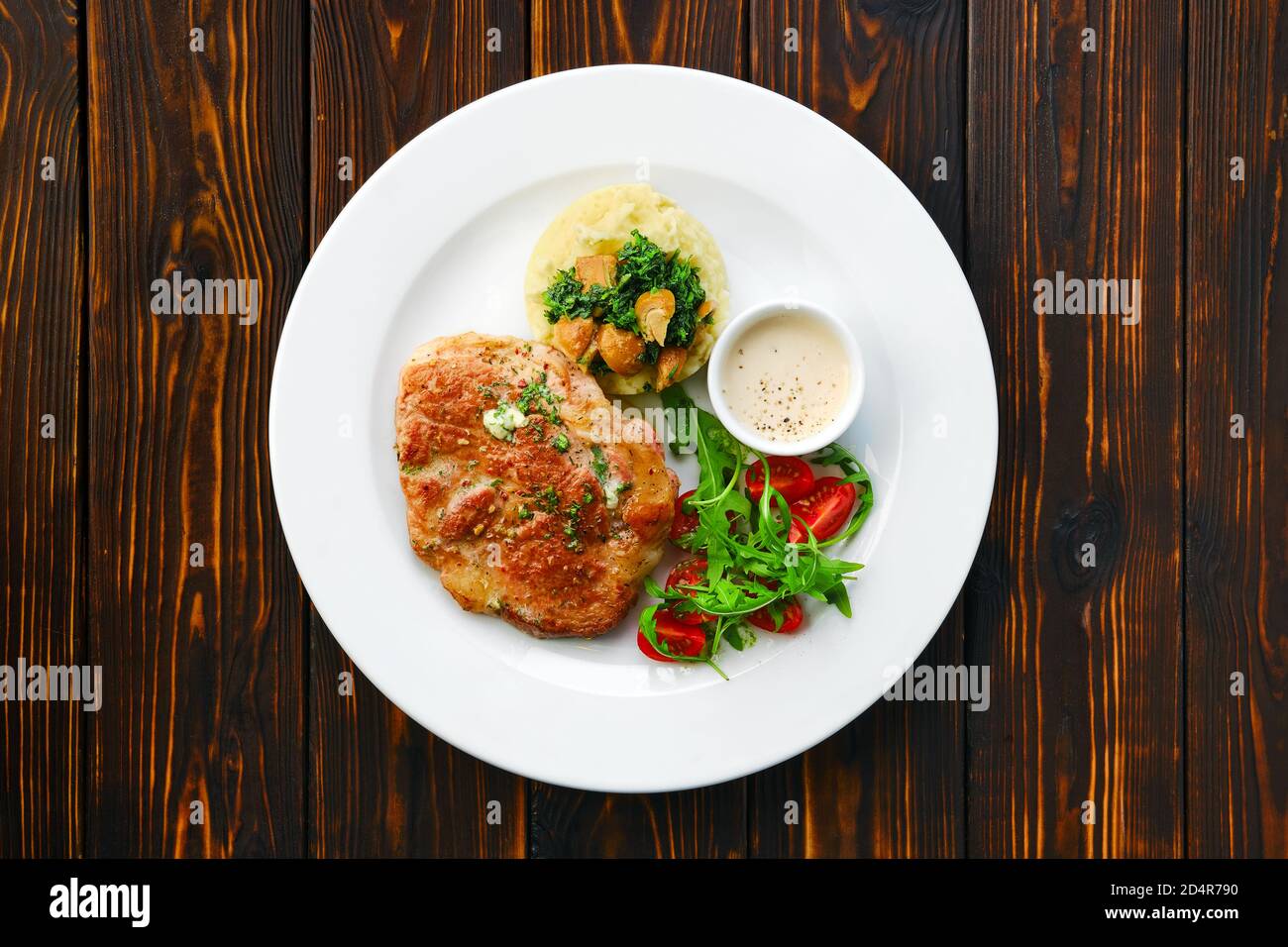 Top view of fried chop pork cutlet with mashed potato and boletus ...