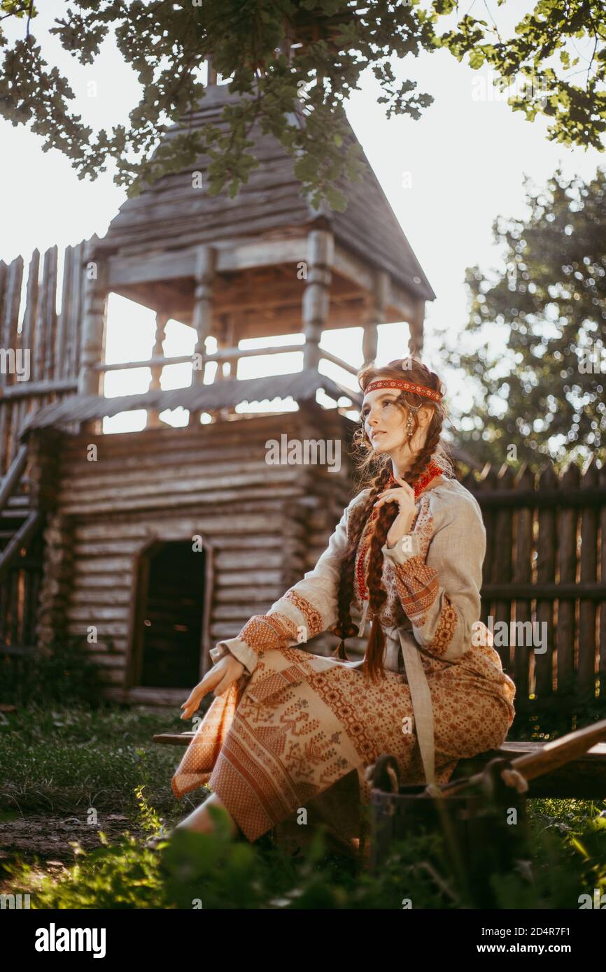 A beautiful Slavic girl with long blonde hair and brown eyes in a white ...