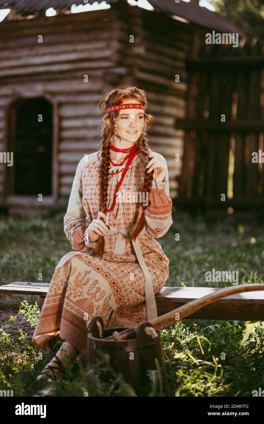 A beautiful Slavic girl with long blonde hair and brown eyes in a white ...