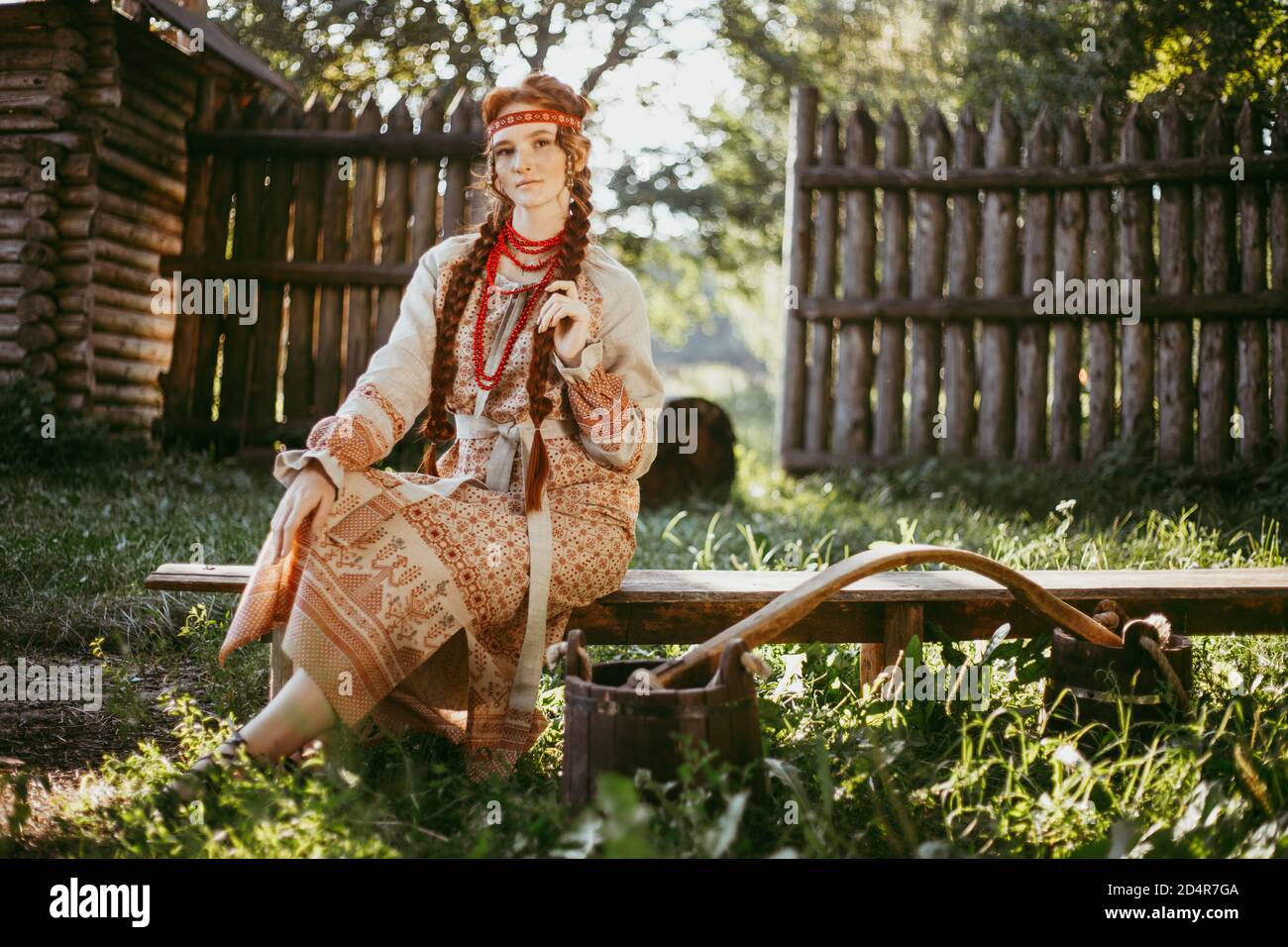 A beautiful Slavic girl with long blonde hair and brown eyes in a white ...