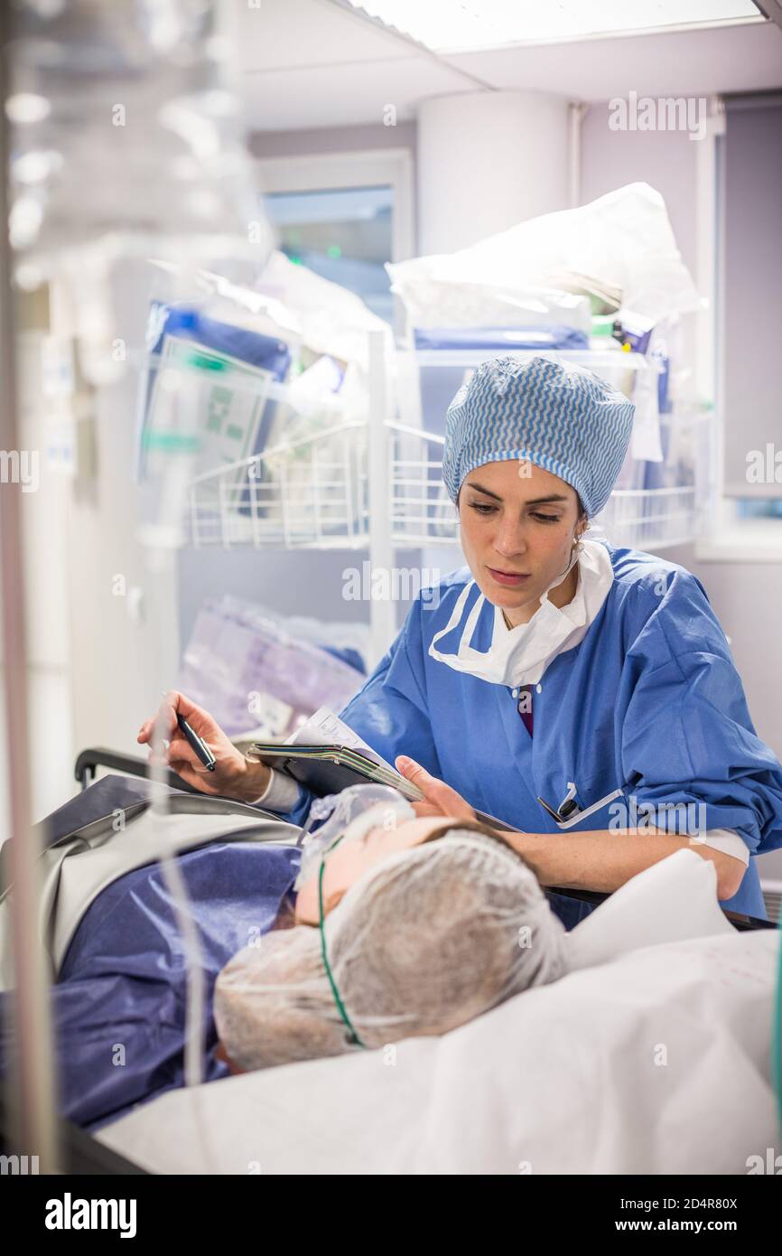 Nurse with patient in post interventional surveillance room after ...