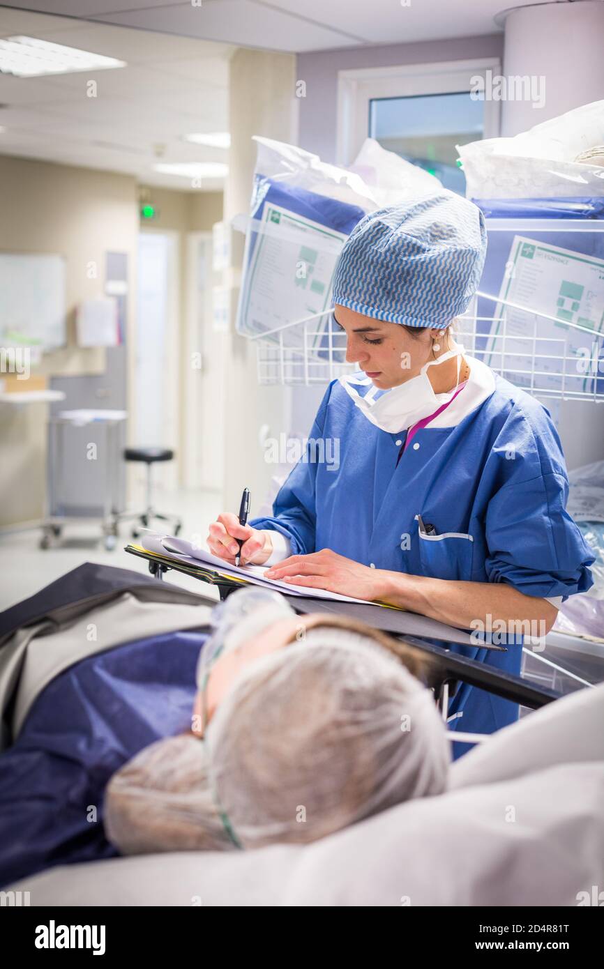 Nurse with patient in post interventional surveillance room after ...