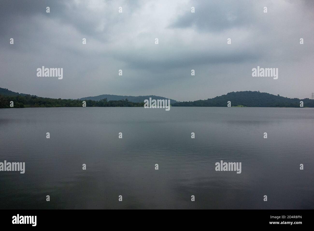 Pleasant view of Amthane Dam reservoir on an overcast day during ...