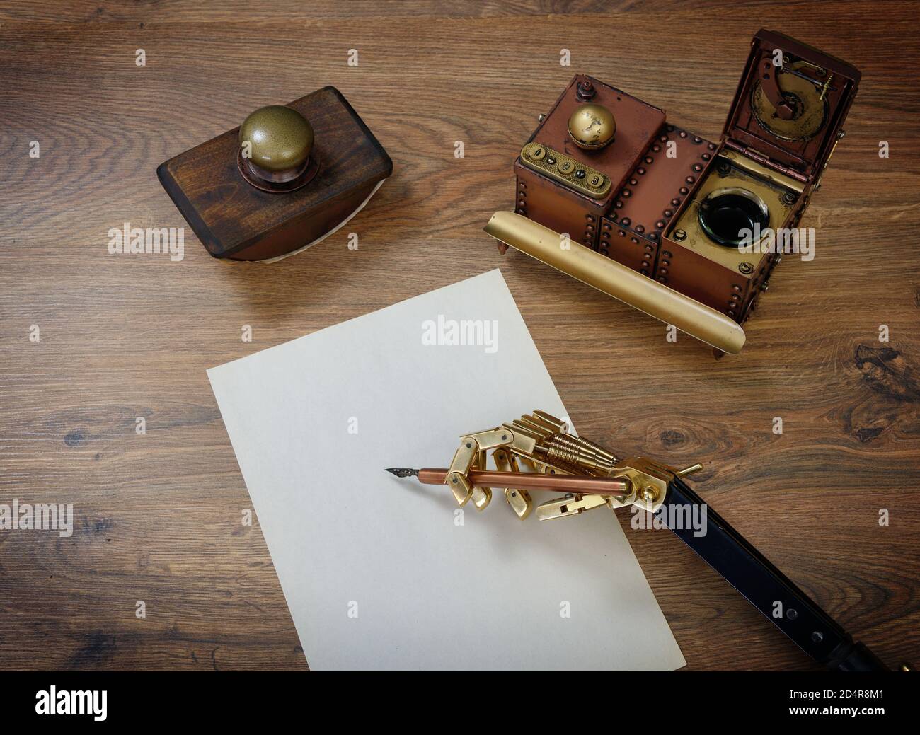 Mechanical hand with ink pen on paper. Top view of sheet of paper at ...