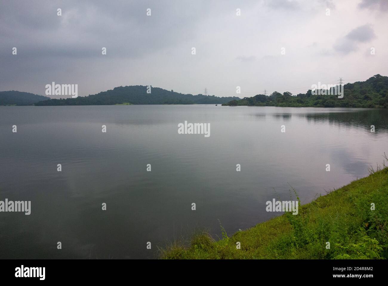 Pleasant view of Amthane Dam reservoir on an overcast day during ...