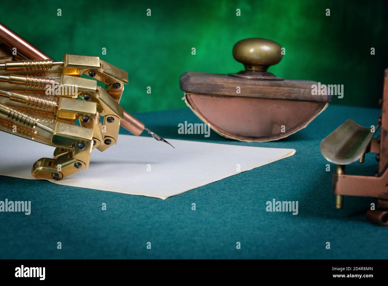 Mechanical hand with ink pen on paper. Focus on the nib Stock Photo - Alamy