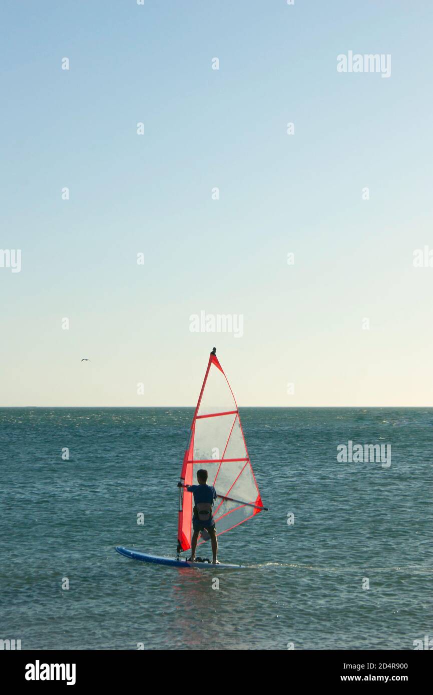 Man doing windsurf in the ocean the horizon has in the middle of the ...