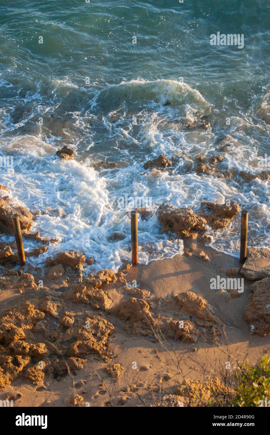 Waves, sand and coastline with rocks sand, and water.the ocean water ...