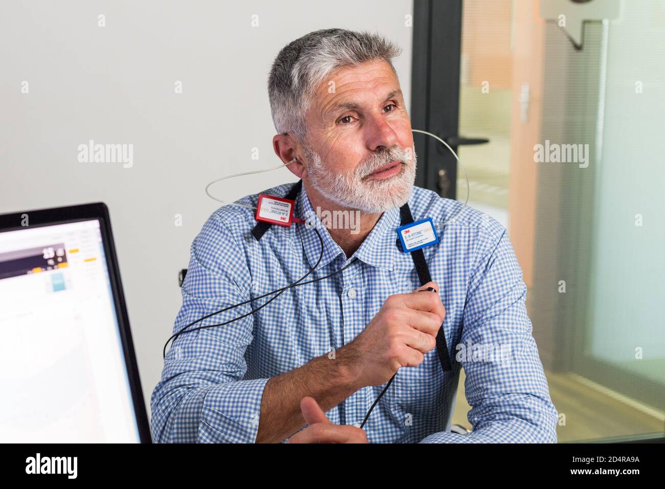 Man undergoing pure-tone audiometry test and hearing threshold ...