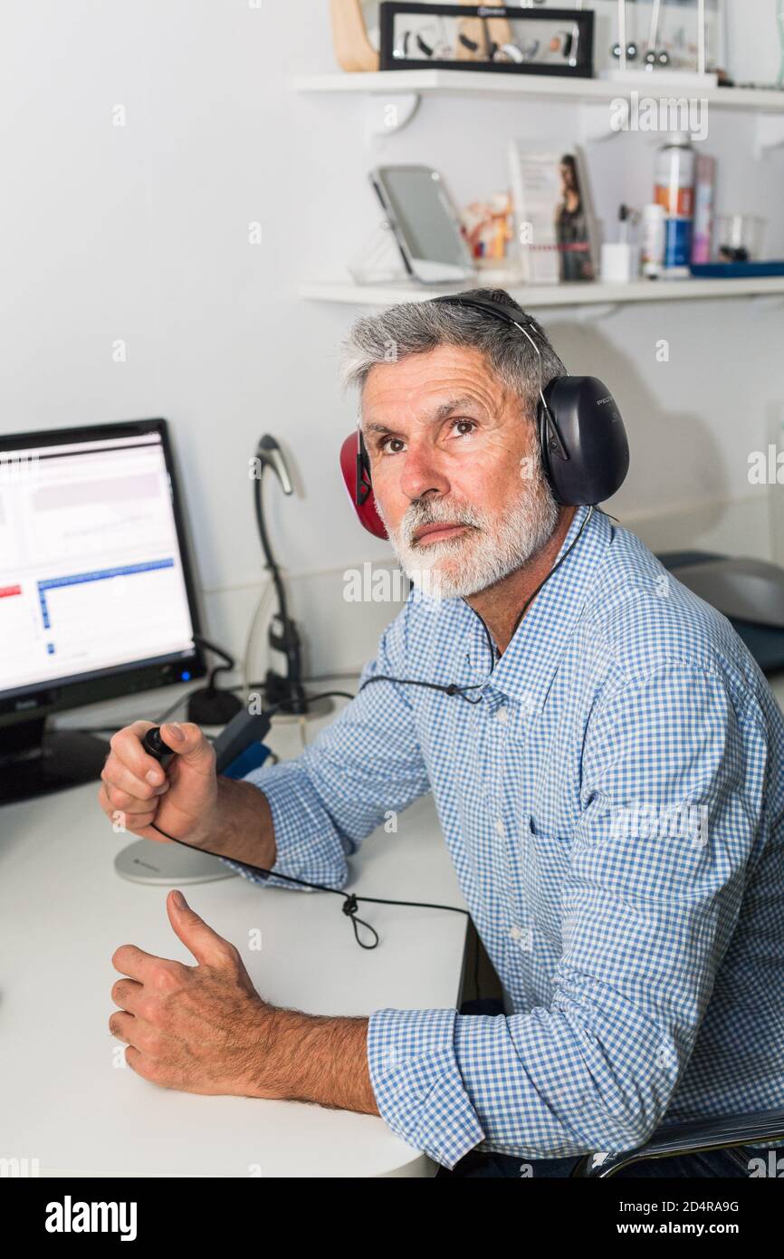 Man undergoing pure-tone audiometry test and hearing threshold ...