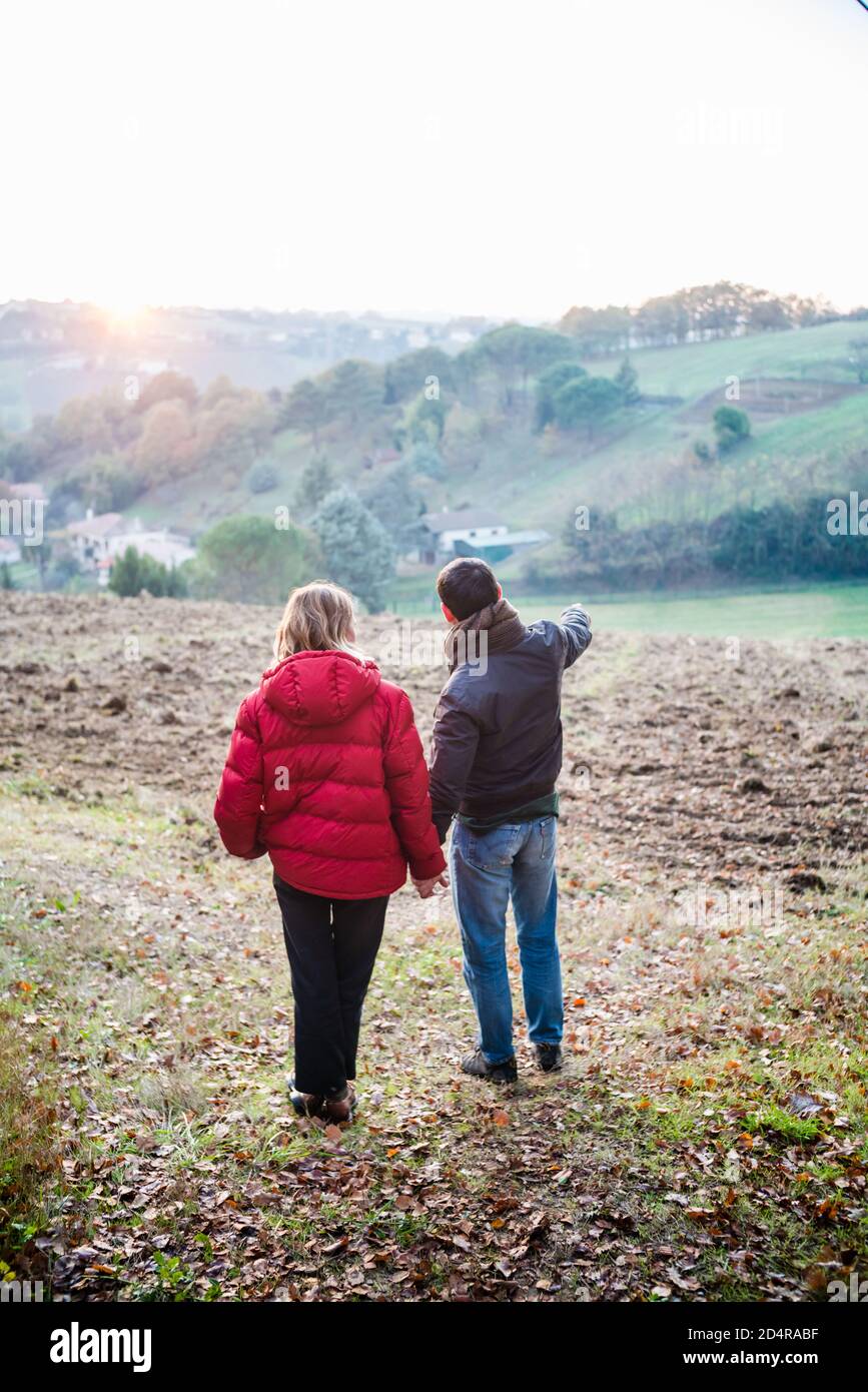 Couple visiting a land in the countryside Stock Photo - Alamy
