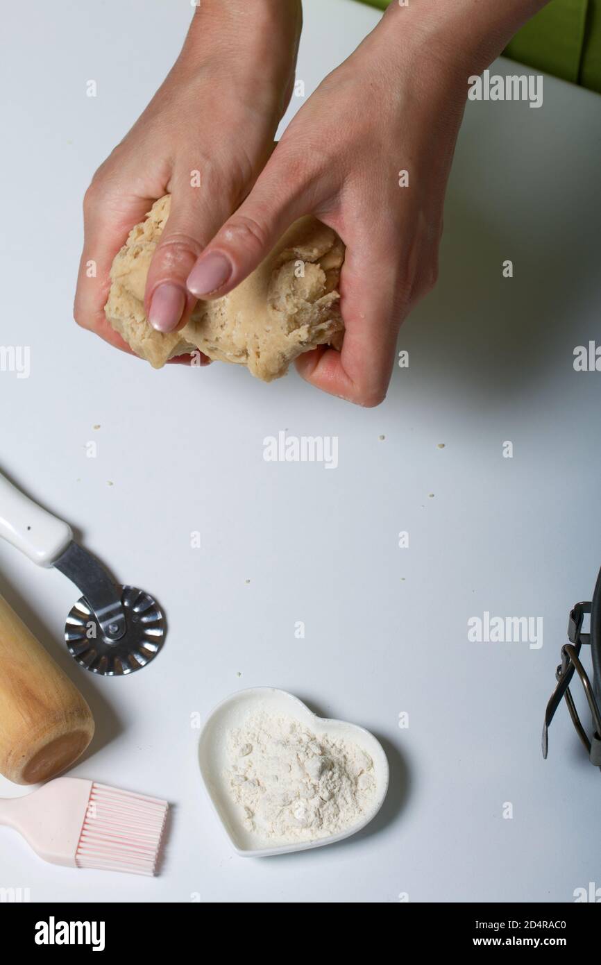 The woman is kneading the dough. Cooking tools are nearby. Levington ...