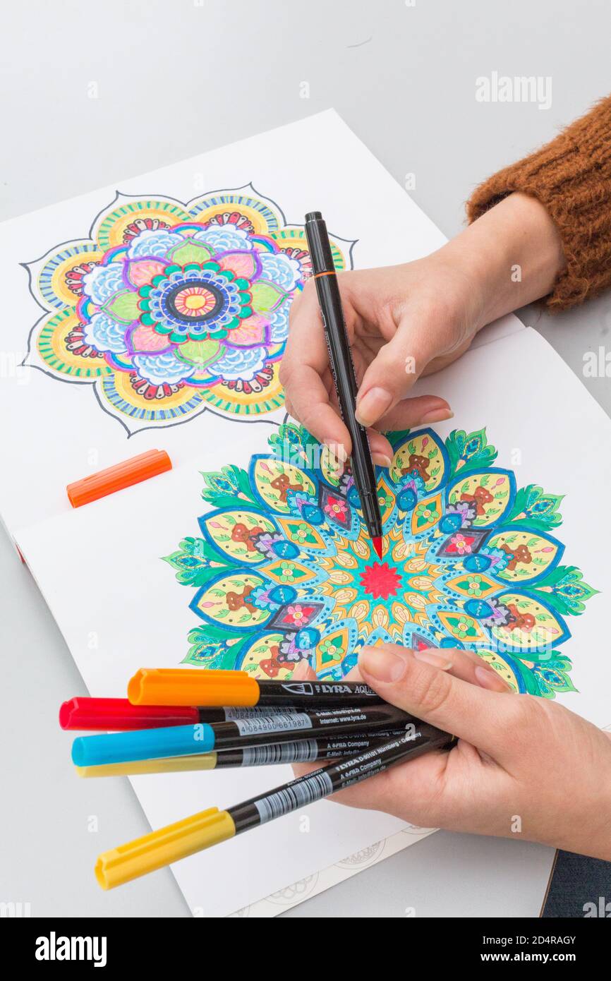 Woman coloring a mandala Stock Photo - Alamy