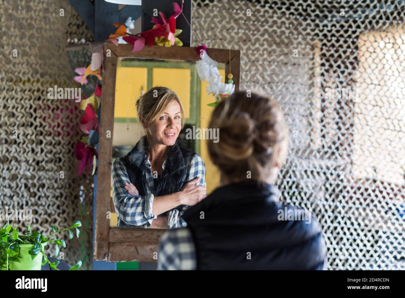 Woman checking in the mirror Stock Photo - Alamy