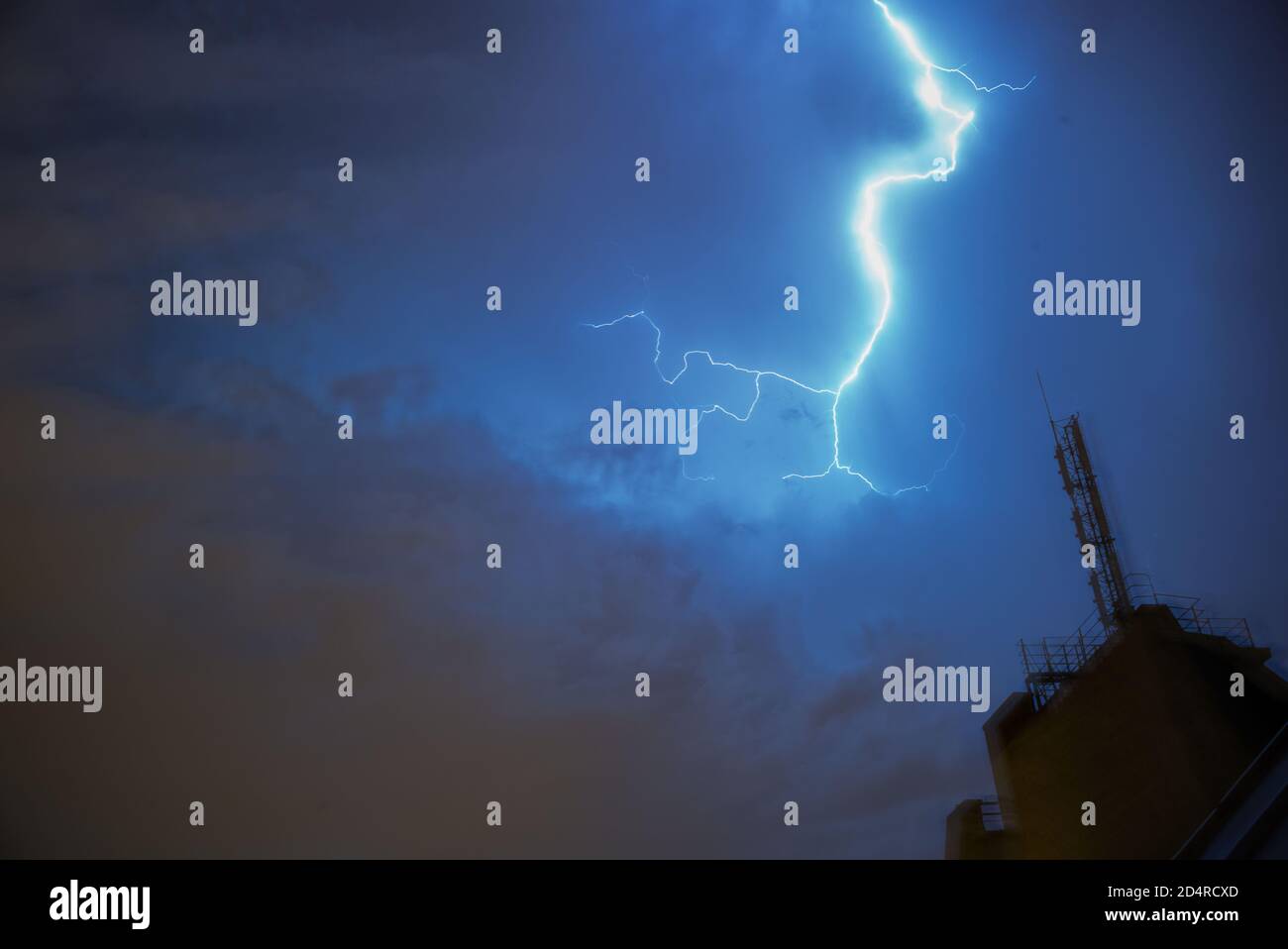 Lightning during a storm and mobile phone relay aerial Stock Photo - Alamy