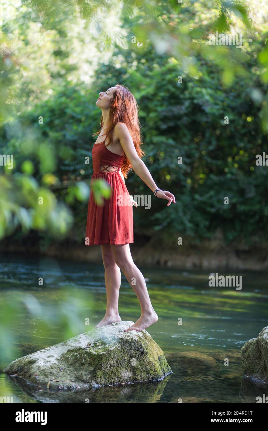 Woman walking on rocks Stock Photo - Alamy