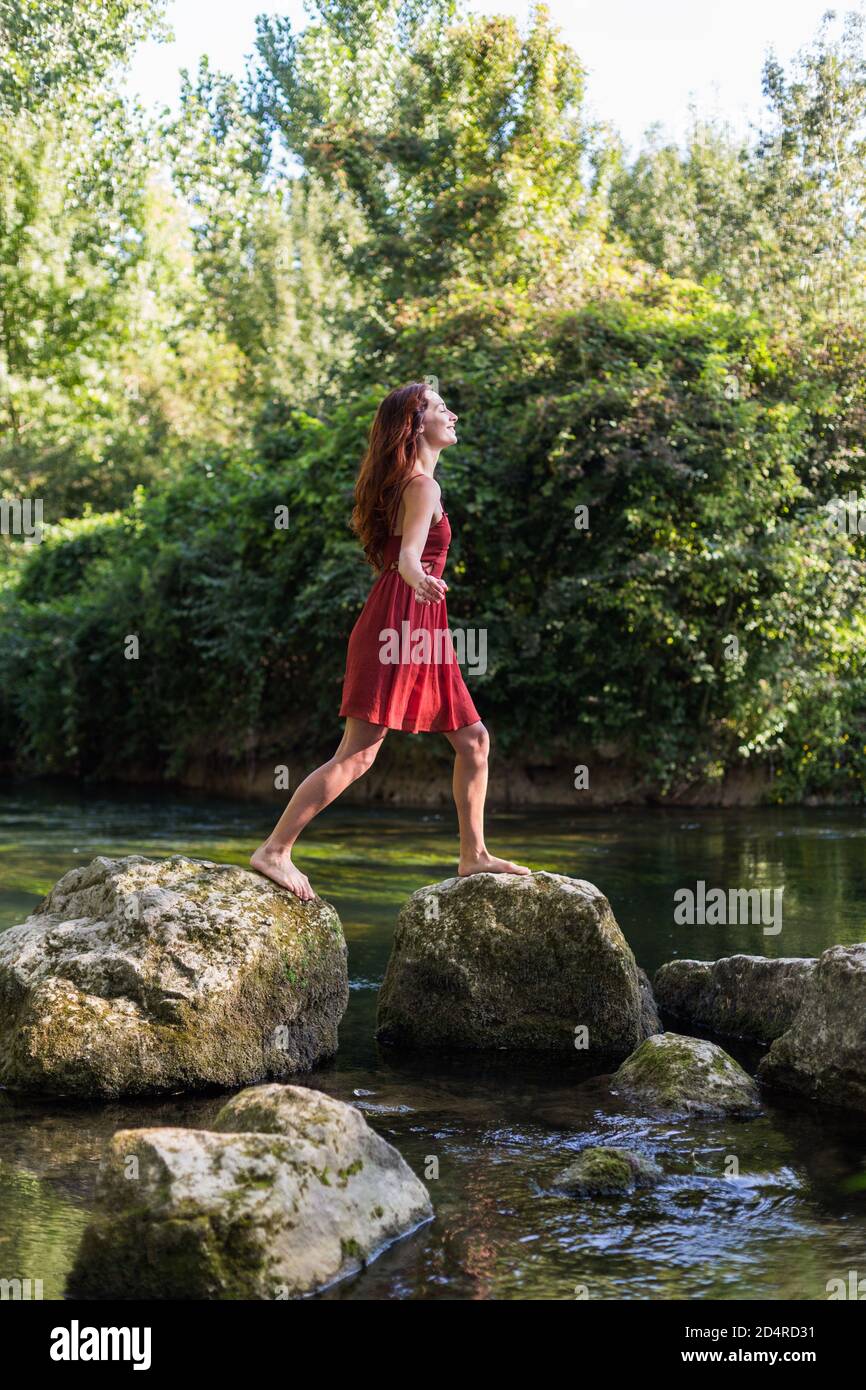 Woman walking on rocks Stock Photo - Alamy