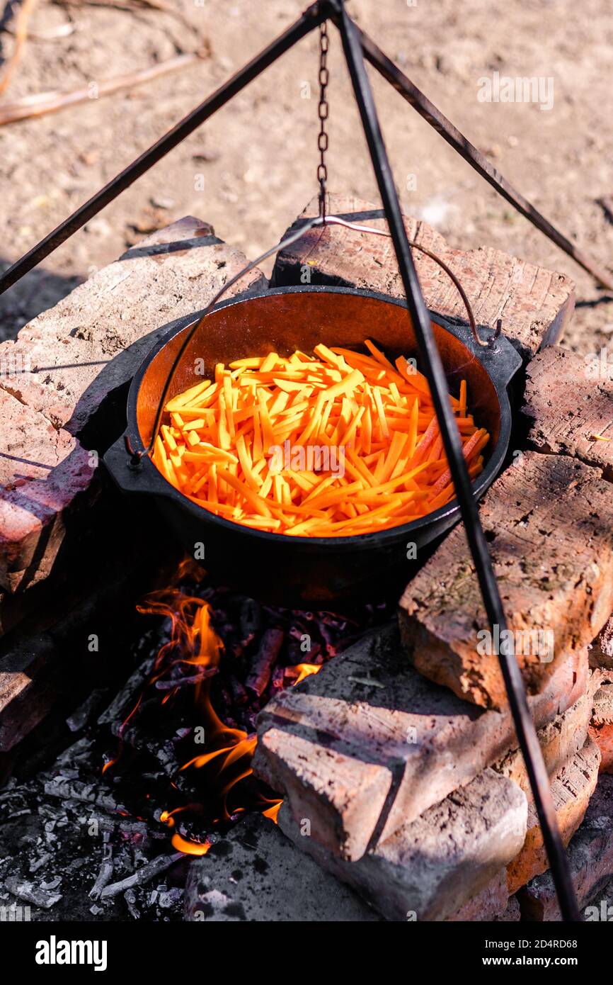 Preparation of raditional armenian pilaf in a cauldron on an open fire ...