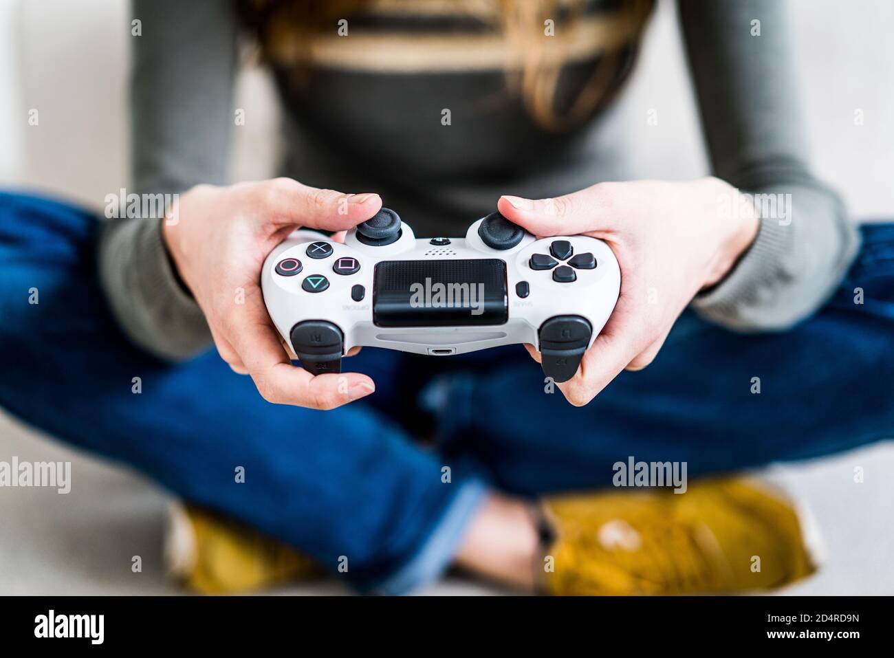 Woman playing a video game using a handheld control Stock Photo - Alamy