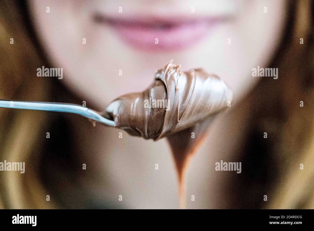 Woman eating jam Nutella ® Stock Photo - Alamy