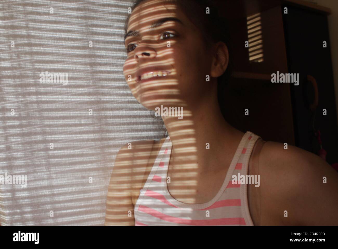 Close-up of a young girl's face looking out the window Stock Photo - Alamy