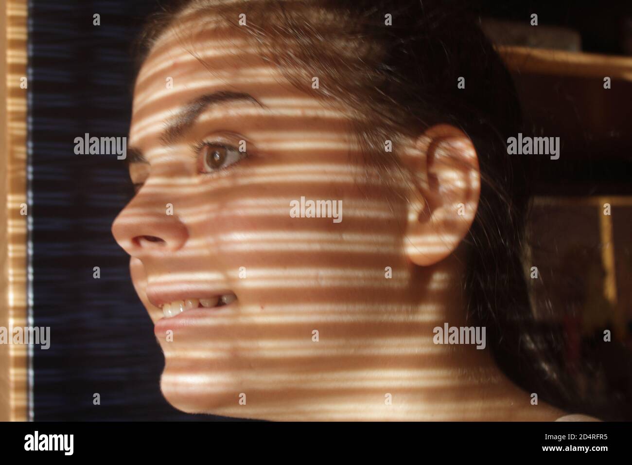 Close-up of a young girl's face looking out the window Stock Photo - Alamy