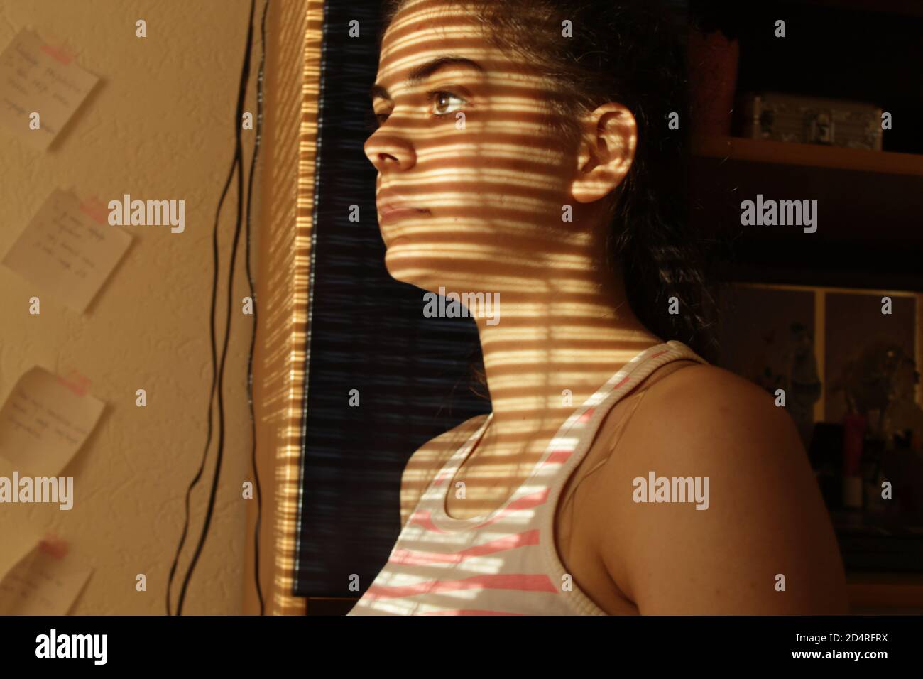 Close-up of a young girl's face looking out the window Stock Photo - Alamy