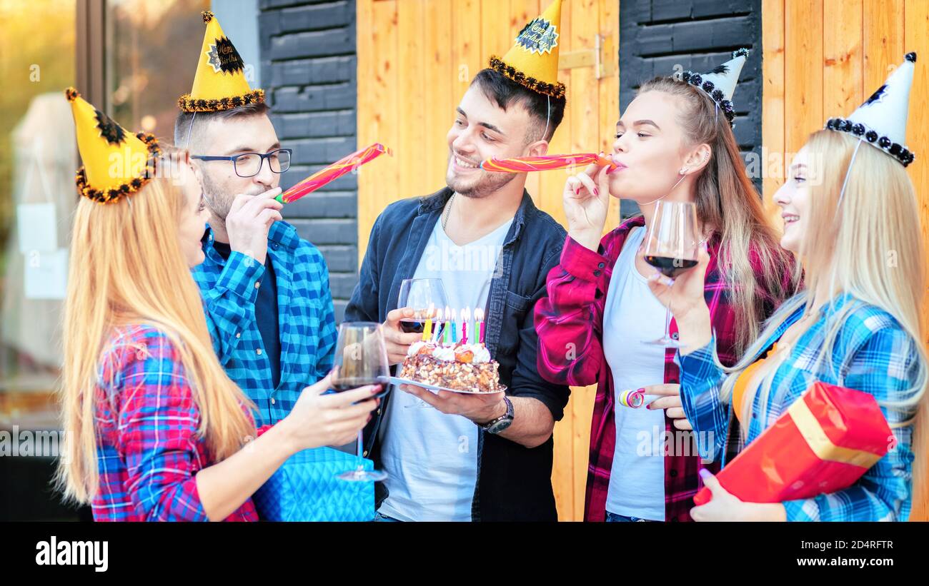 Birthday party with young friends celebrating with cake and wine Stock ...