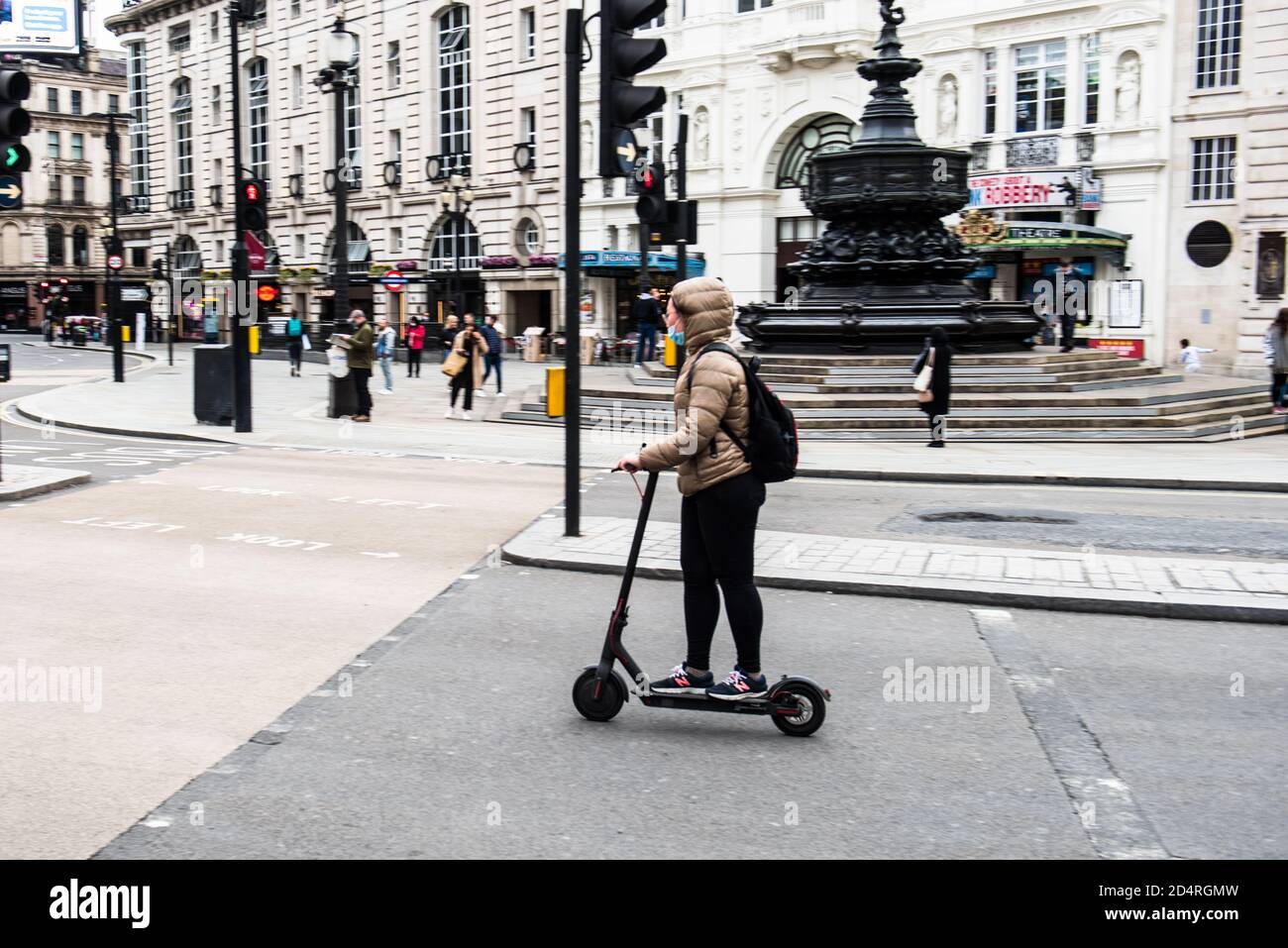 Electric scooter ridden by women in London Piccadilly Circus Stock ...