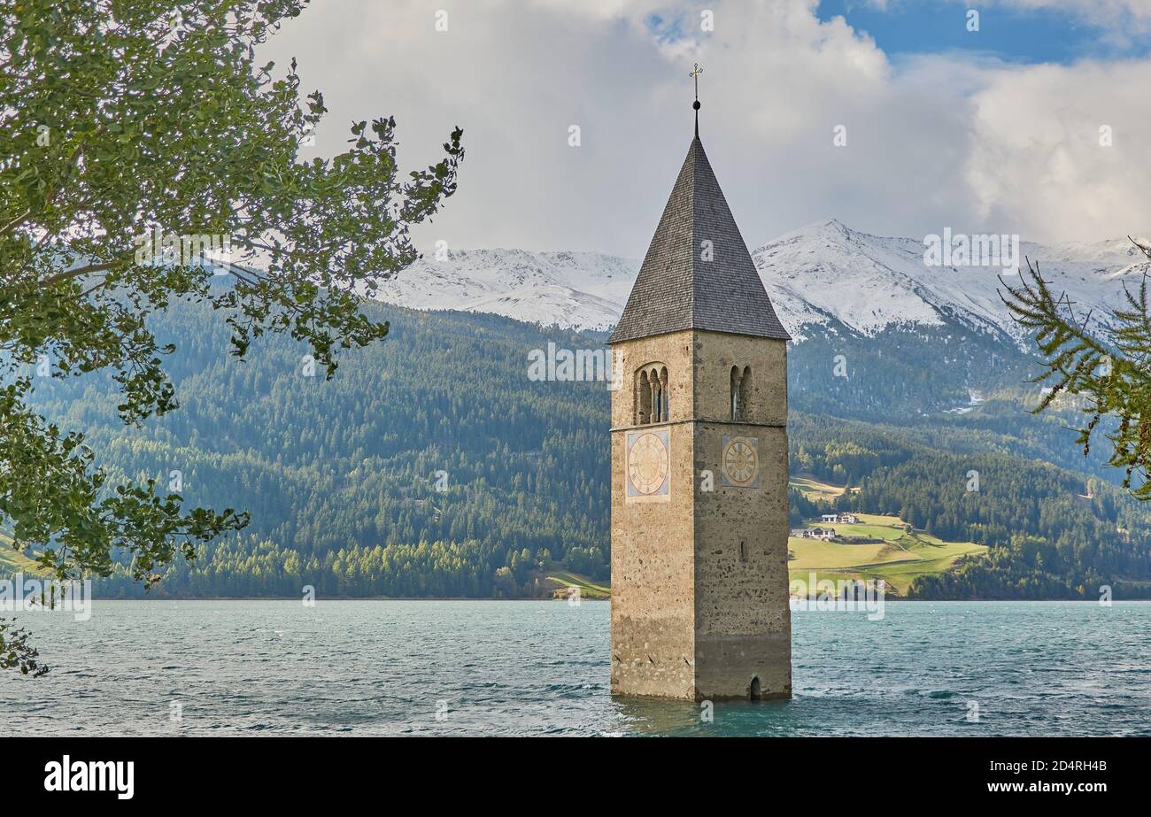 Submerged church tower in the lake reschen in tirol. Lago di Resia with ...