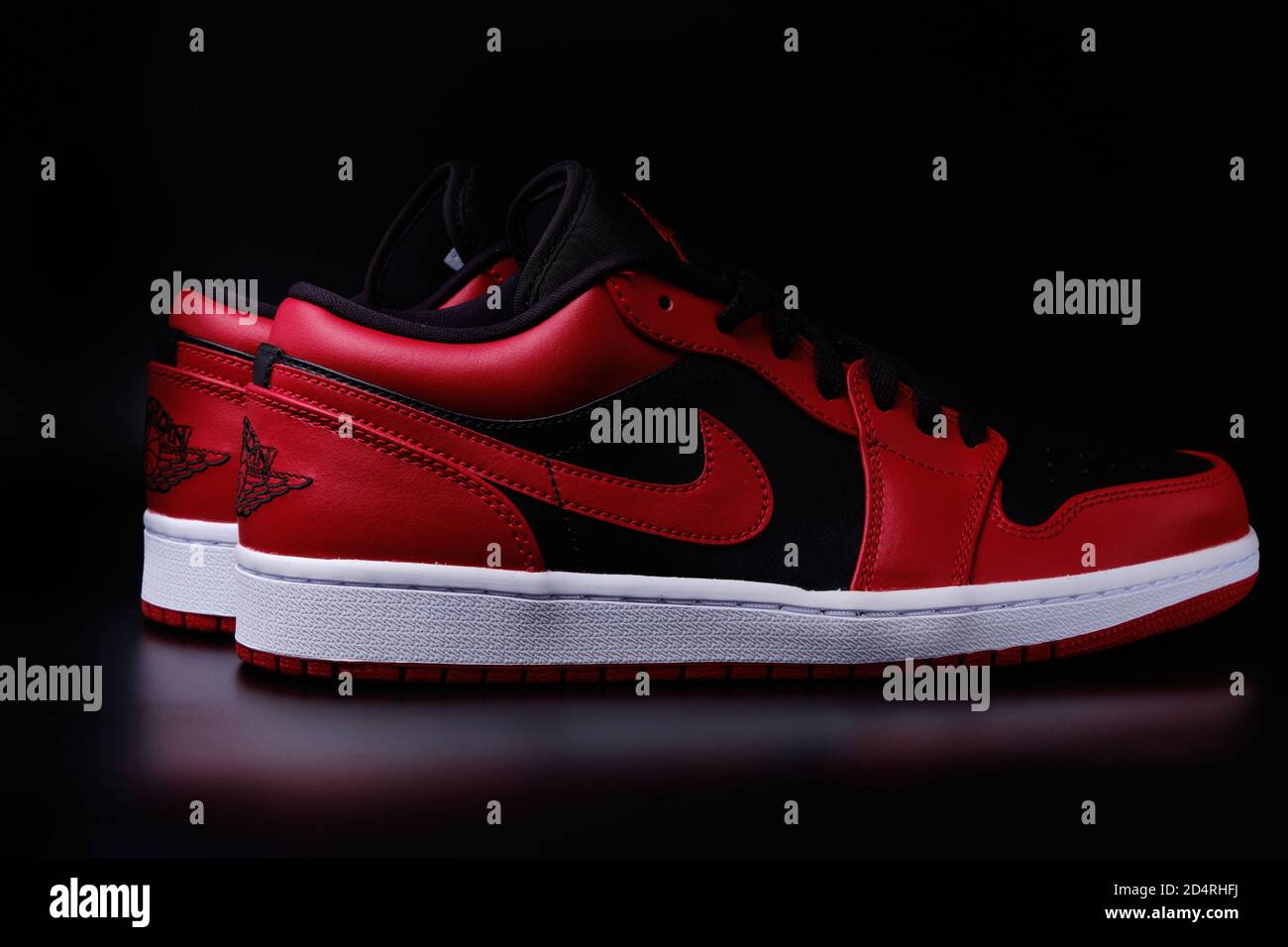 Nike Air Jordan 1 Retro Low Reverse Bred colorway sneakers on black ...