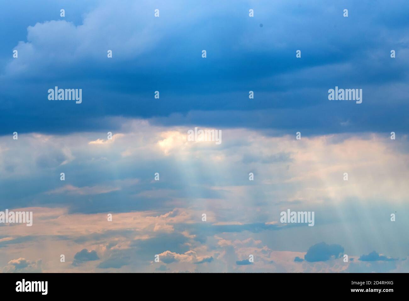 Heavenly blue sky with white clouds background and sunburst Stock Photo ...