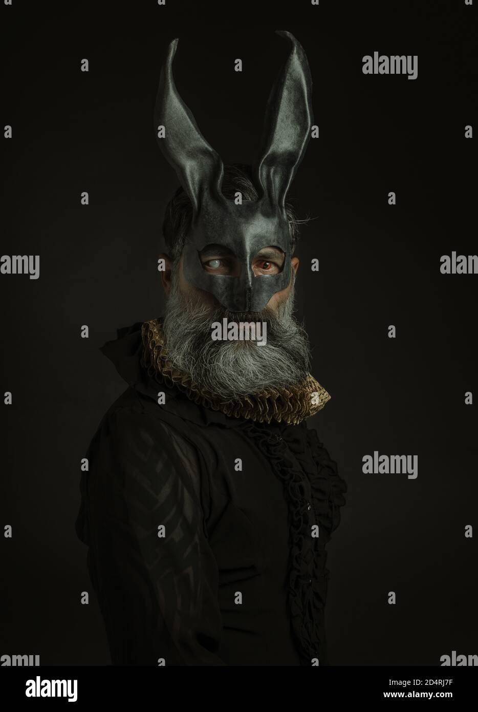 Portrait of an elegant male with a rabbit leather mask on black ...