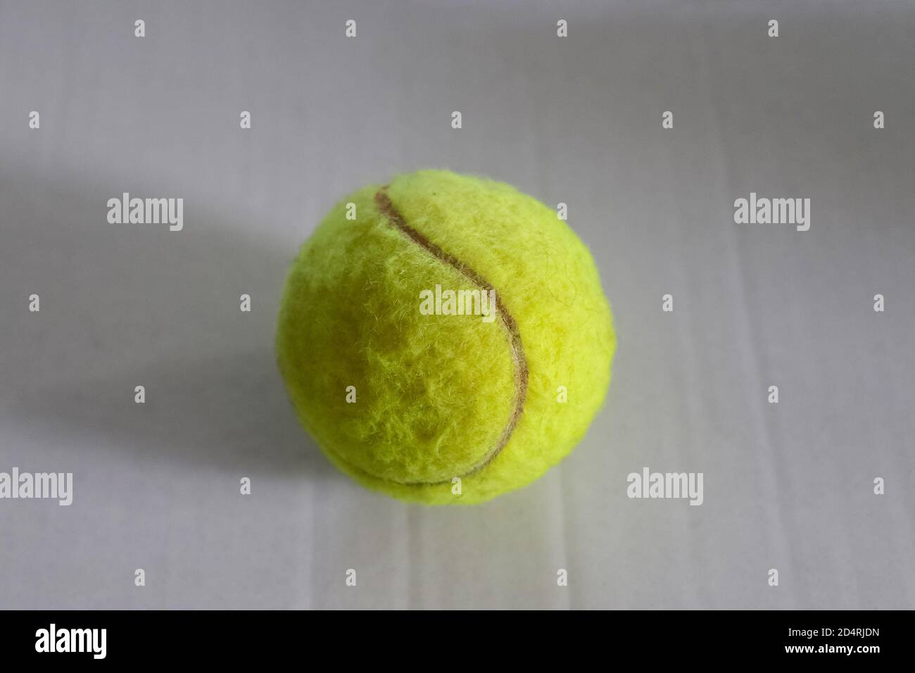 Closeup shot of a fuzzy tennis ball on a white surface Stock Photo - Alamy