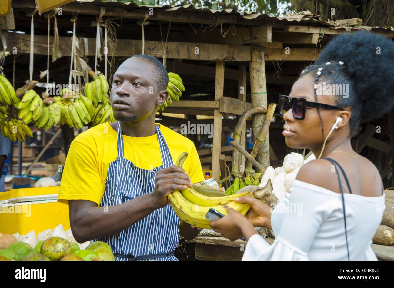 Young African market man feeling excited as he sells his goods to his ...